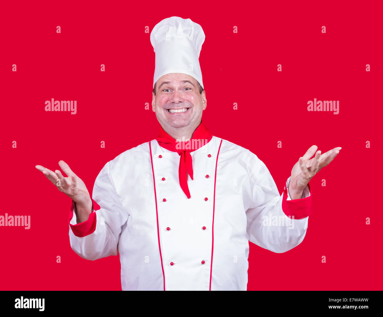cheerful cook on a red background Stock Photo - Alamy