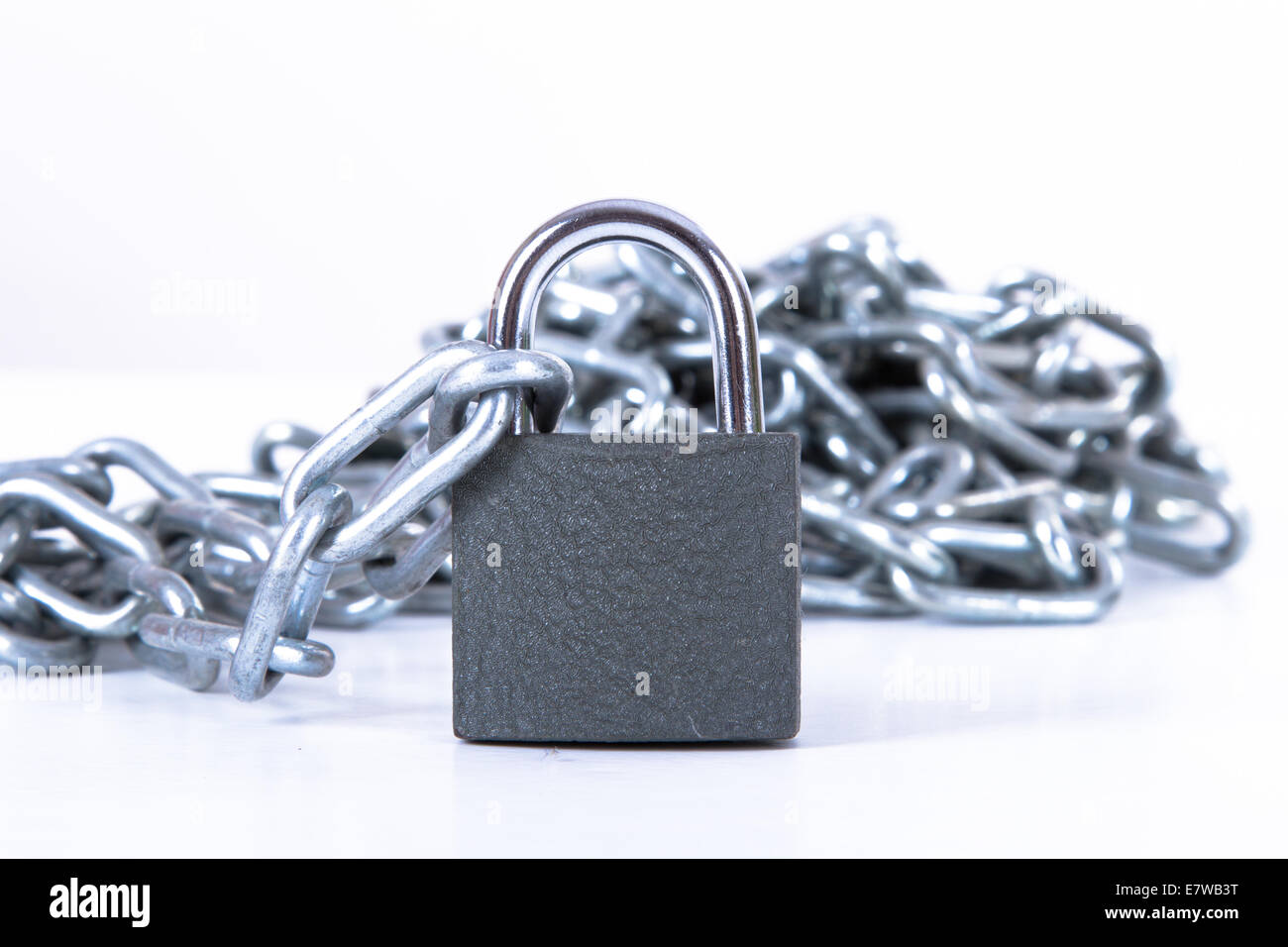 Heap of metal chain with security lock, isolated on white background ...
