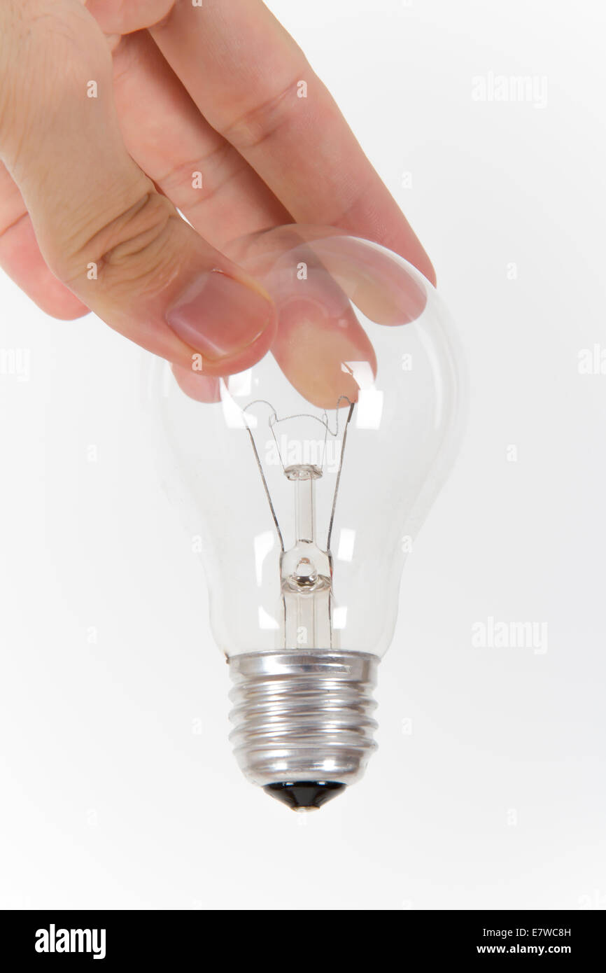 Hand holding light bulb from top on white background Stock Photo - Alamy