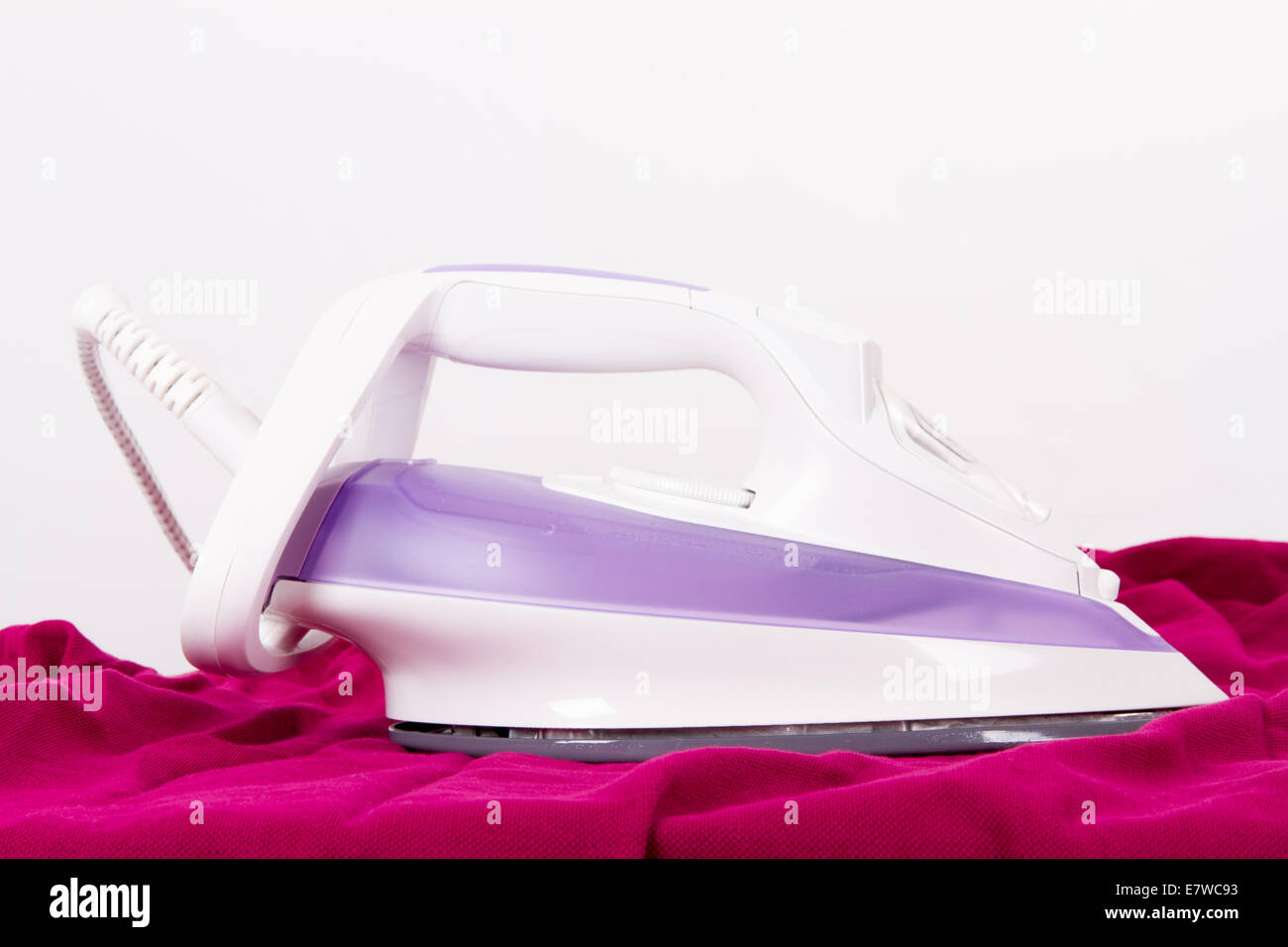 Ironing red shirt, isolated on white background Stock Photo - Alamy
