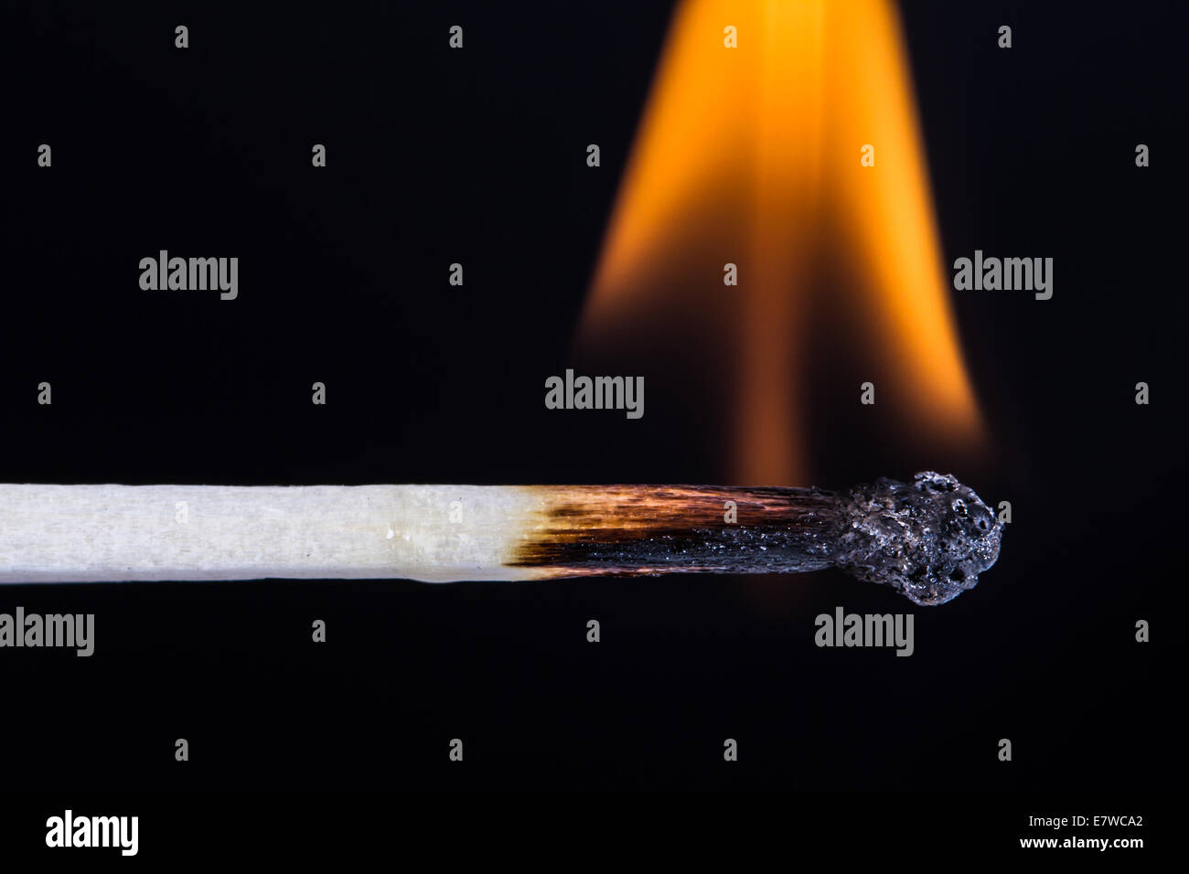 Close up of burning, flaming match on fire against black background ...
