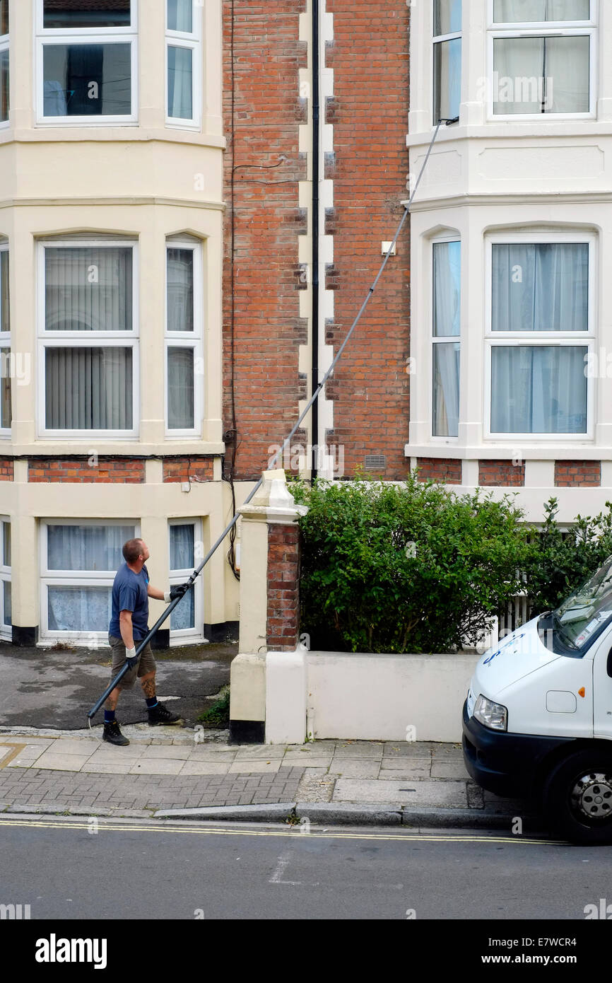 Man window cleaner cleaning long pole hi-res stock photography and ...