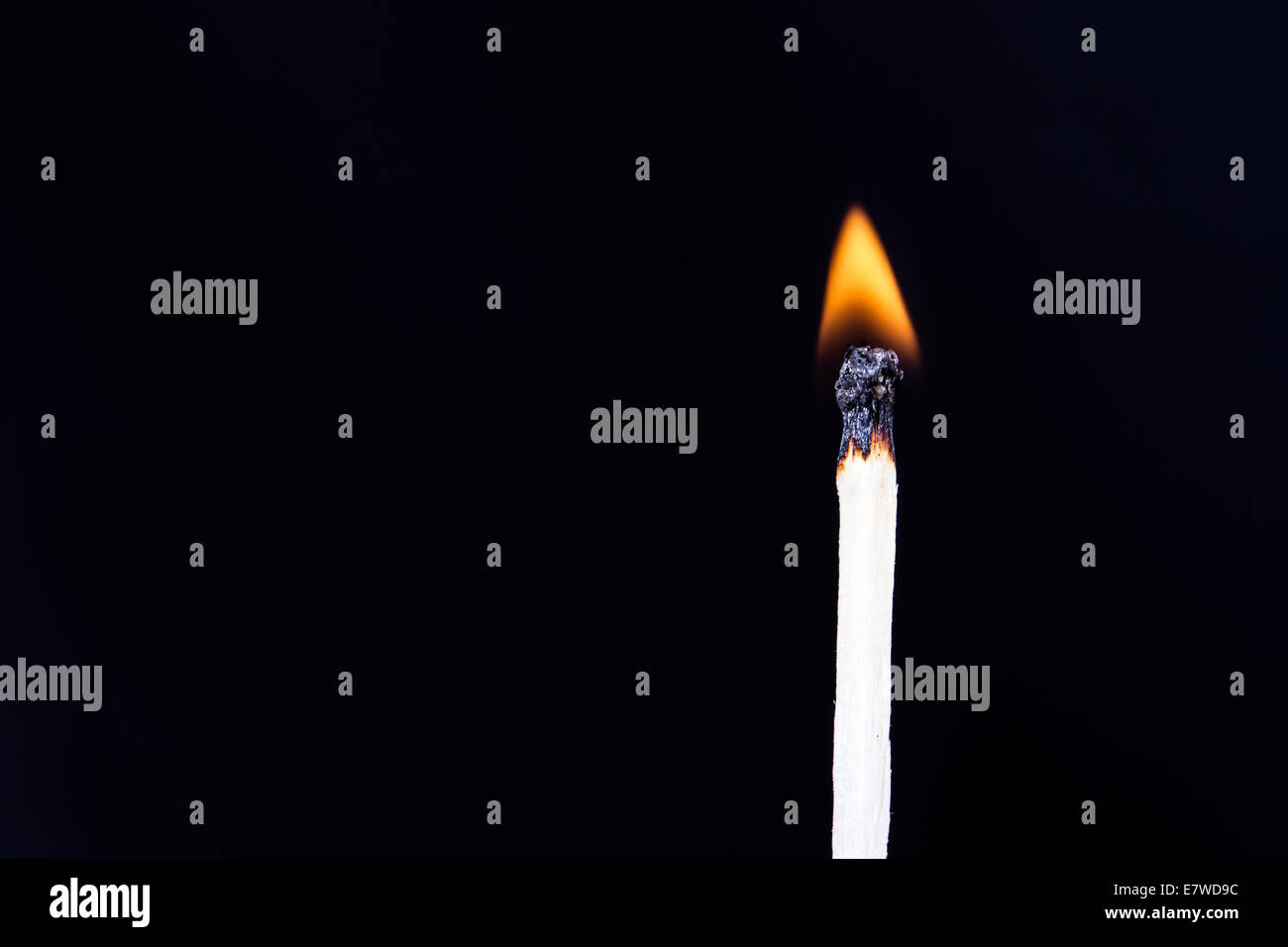 Single match burning on dark background Stock Photo - Alamy