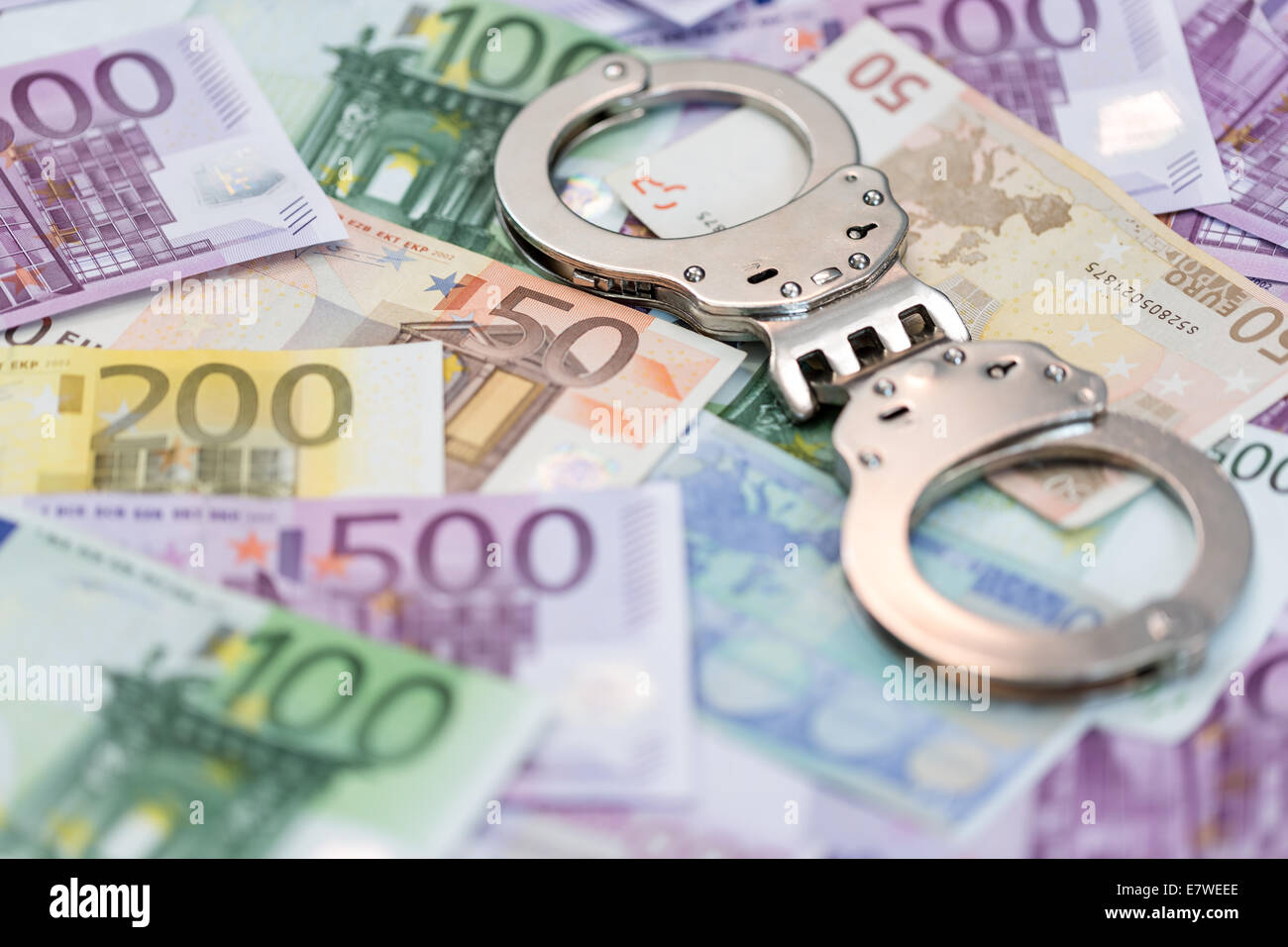 Police handcuffs and EUR money Stock Photo - Alamy