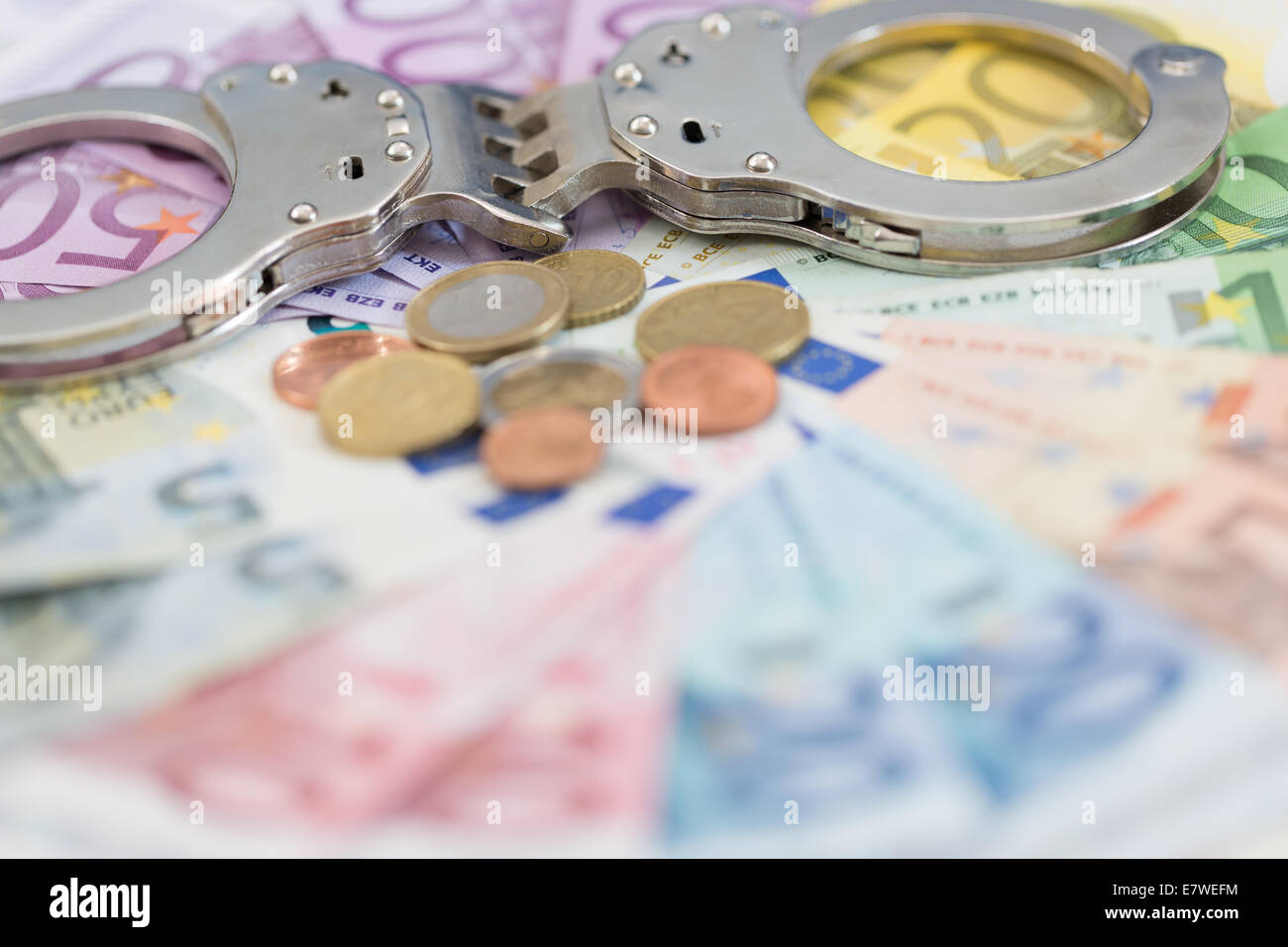 Police handcuffs and EUR money Stock Photo - Alamy