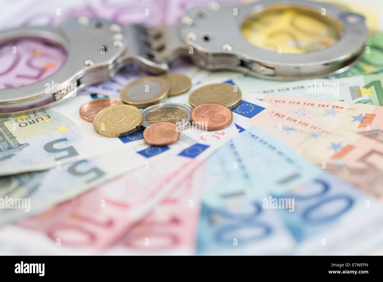 Police handcuffs and EUR money Stock Photo - Alamy