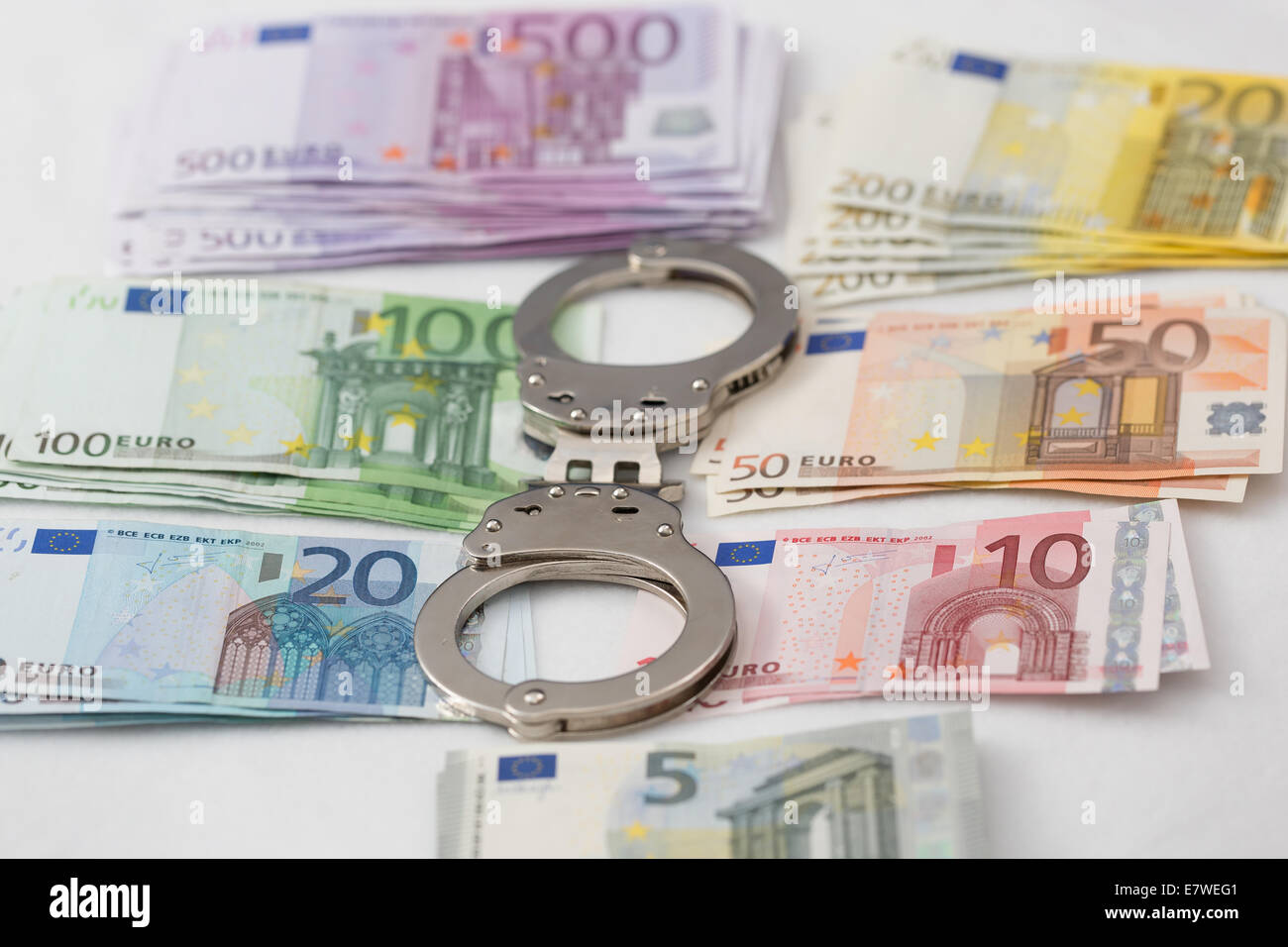Police handcuffs and EUR money Stock Photo - Alamy