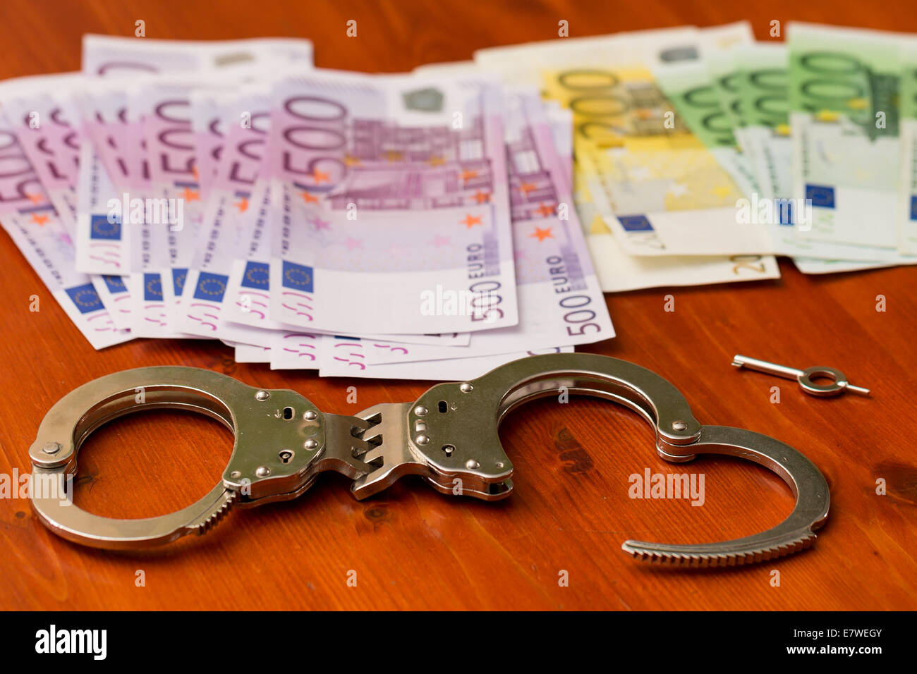 Police handcuffs and EUR money Stock Photo - Alamy