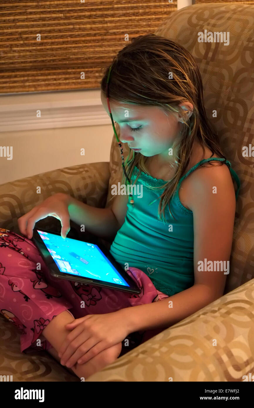 Girl doing school homework on a computer tablet Stock Photo - Alamy