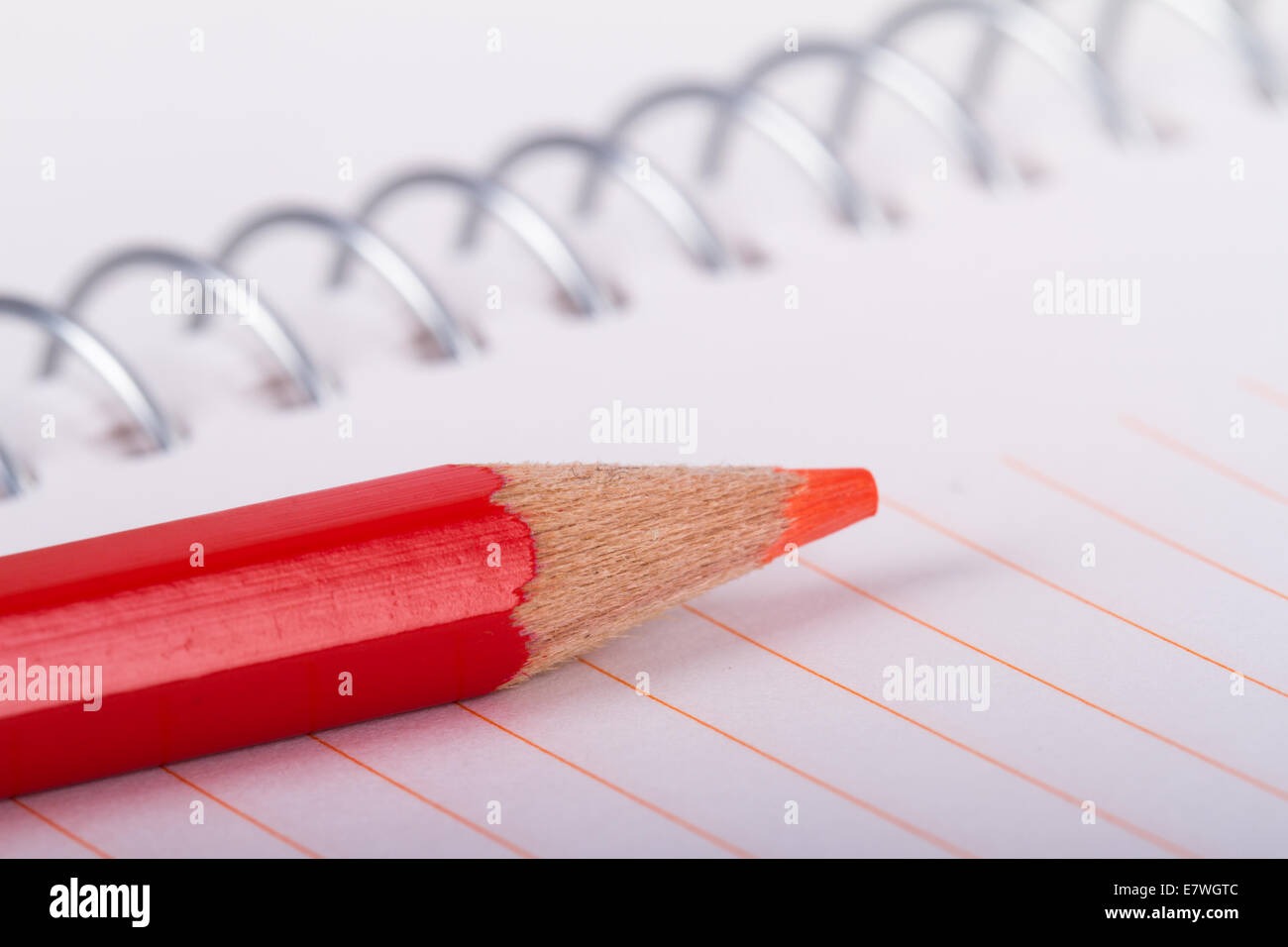 Red pencil on ring binder notebook Stock Photo - Alamy