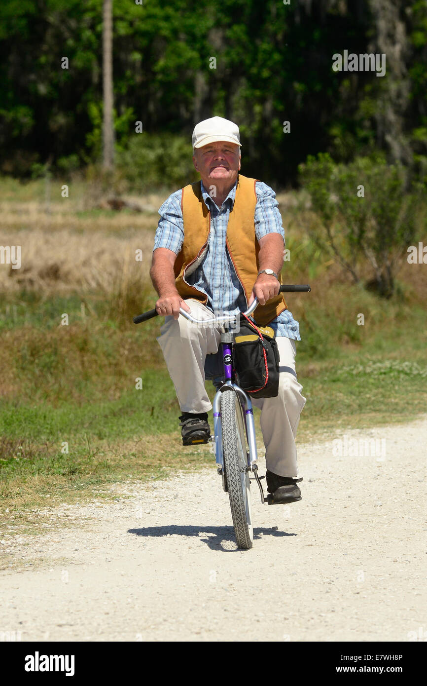 Senior citizen male riding a bicycle outdoors Stock Photo - Alamy
