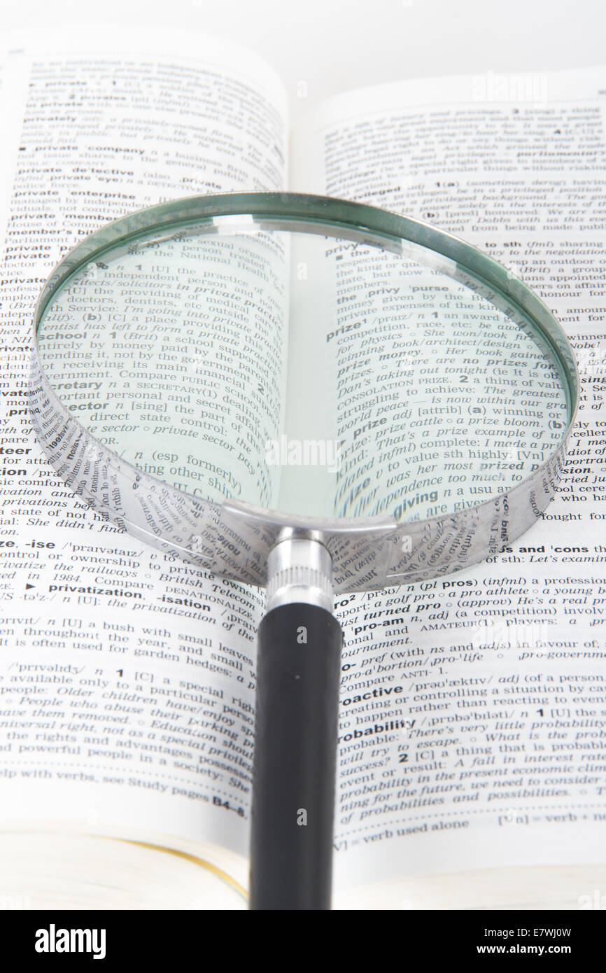 Classic style magnifying glass on open dictionary book Stock Photo - Alamy
