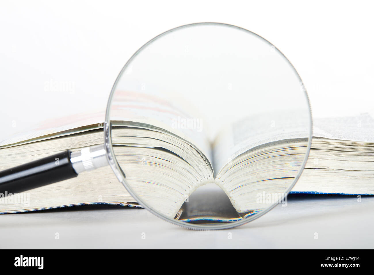 Magnifying glass and open dictionary book, isolated on white background ...