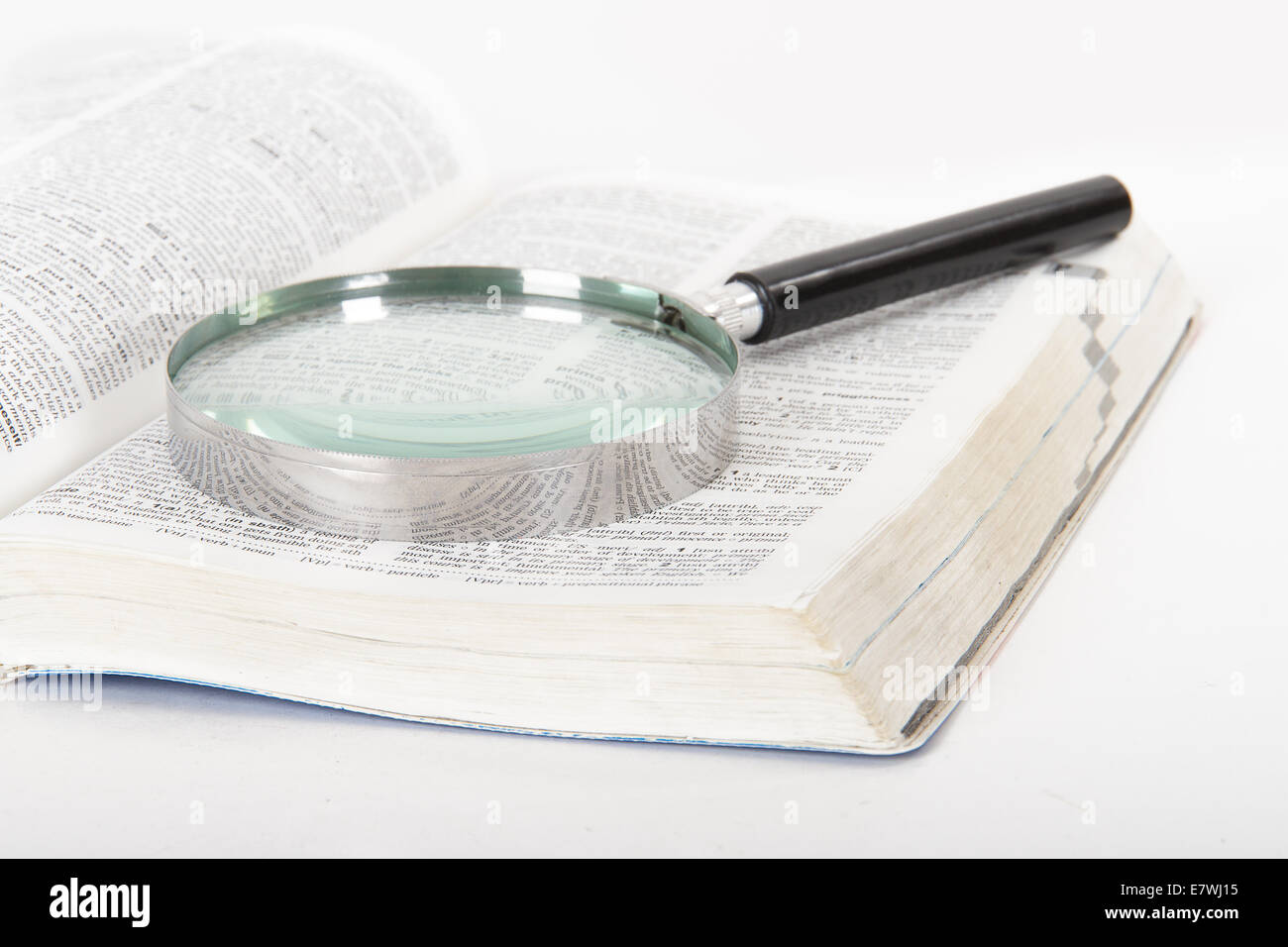 Classic style magnifying glass on open dictionary book, isolated on ...