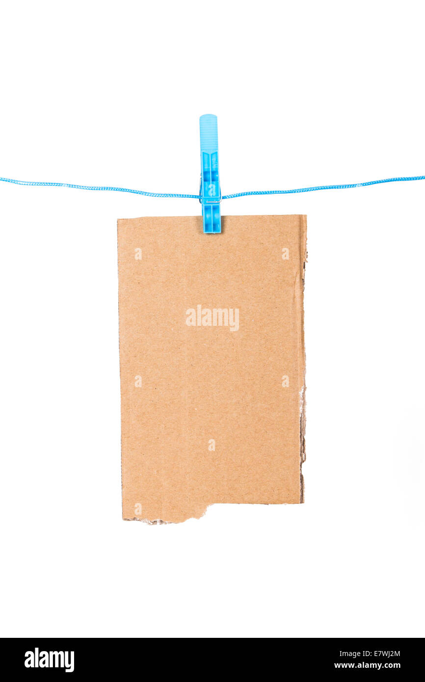 Teared, ripped cardboard with blue, plastic clothespin on nylon rope ...