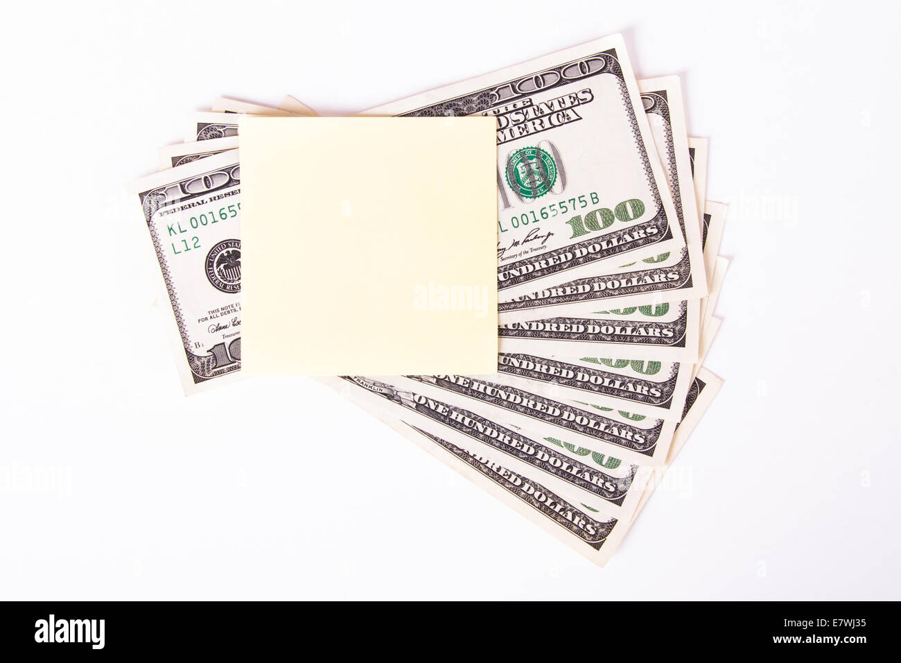 One hundred dollar bills with yellow, blank, empty sticky post it note ...