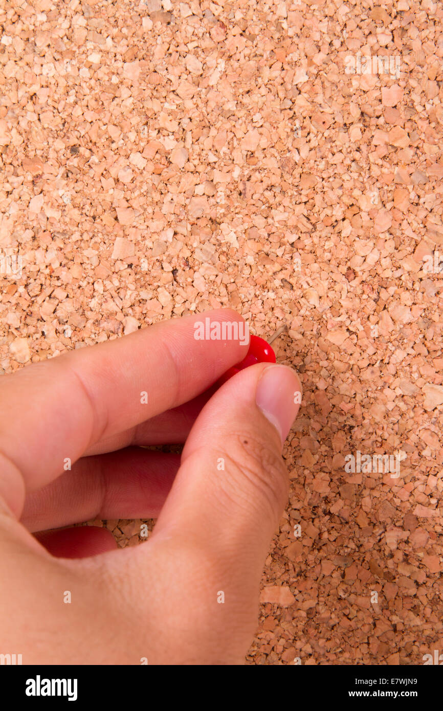 Hand with red push pin on cork bulletin board Stock Photo - Alamy