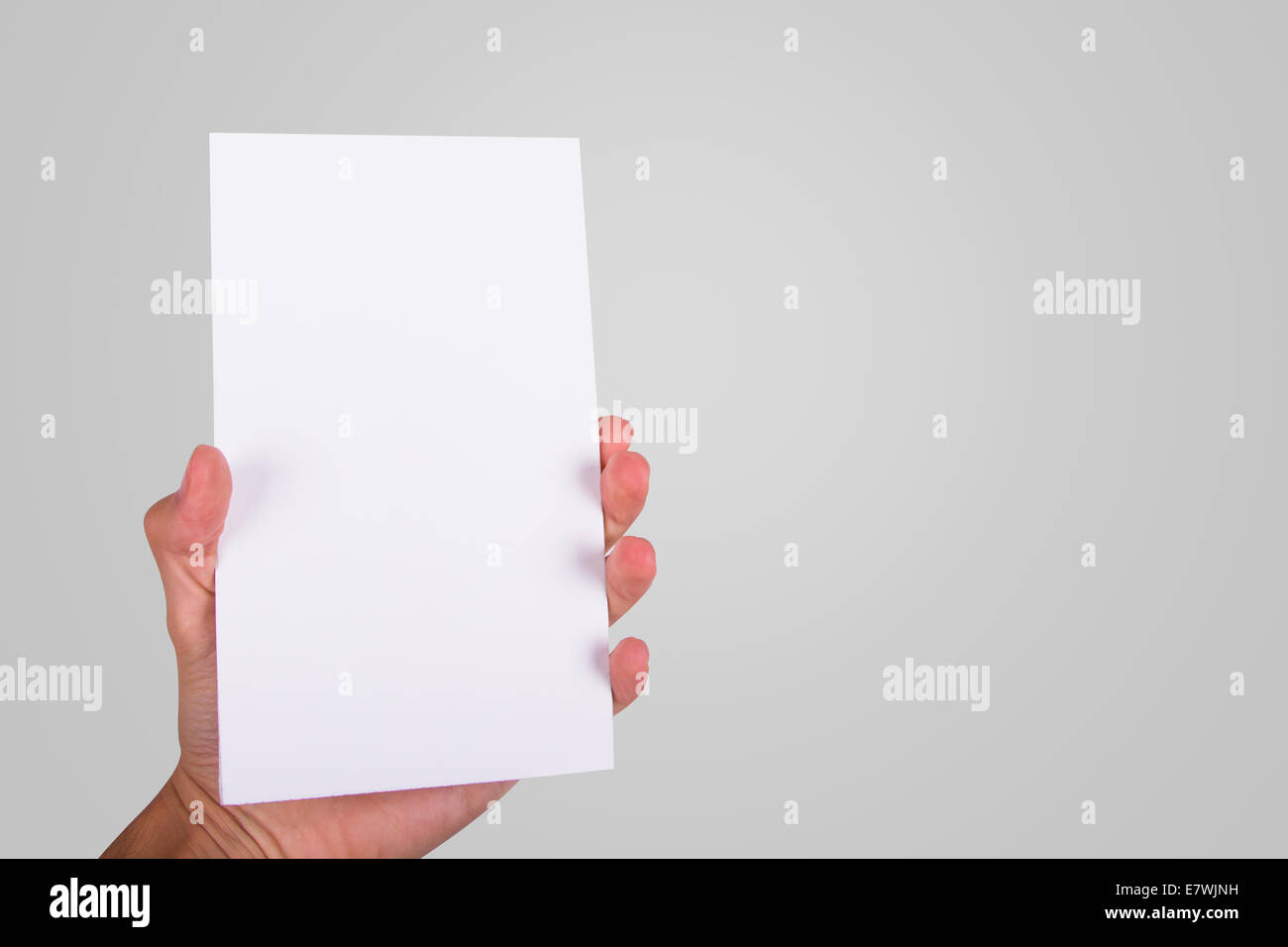 Hand holding and showing white cardboard Stock Photo - Alamy