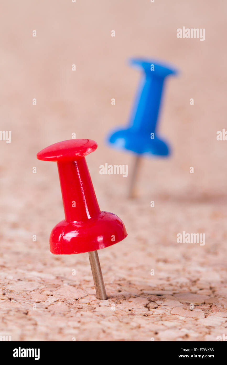 Red and blue push pins on cork bulletin board Stock Photo - Alamy