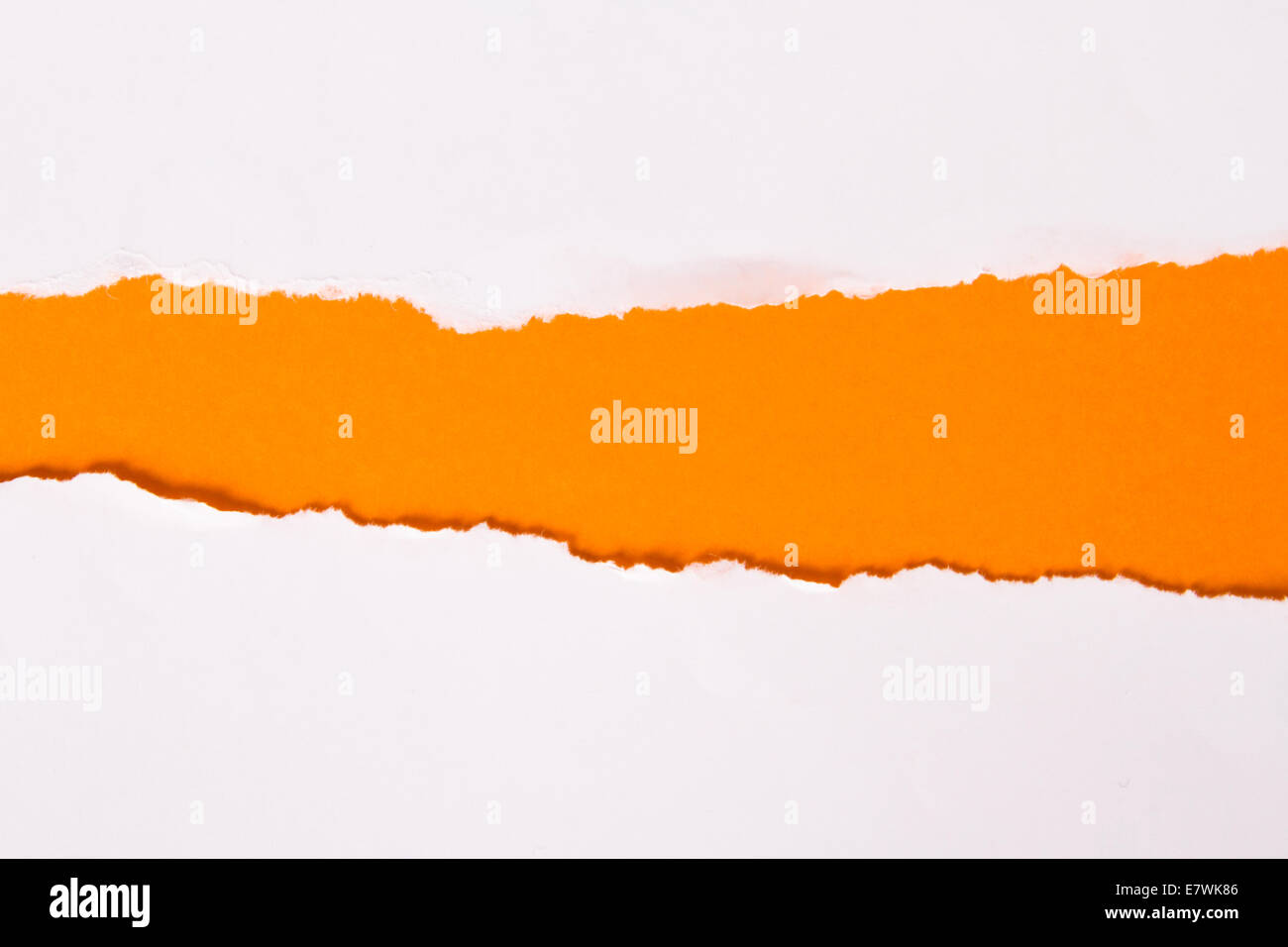 Teared, ripped paper on orange background Stock Photo - Alamy