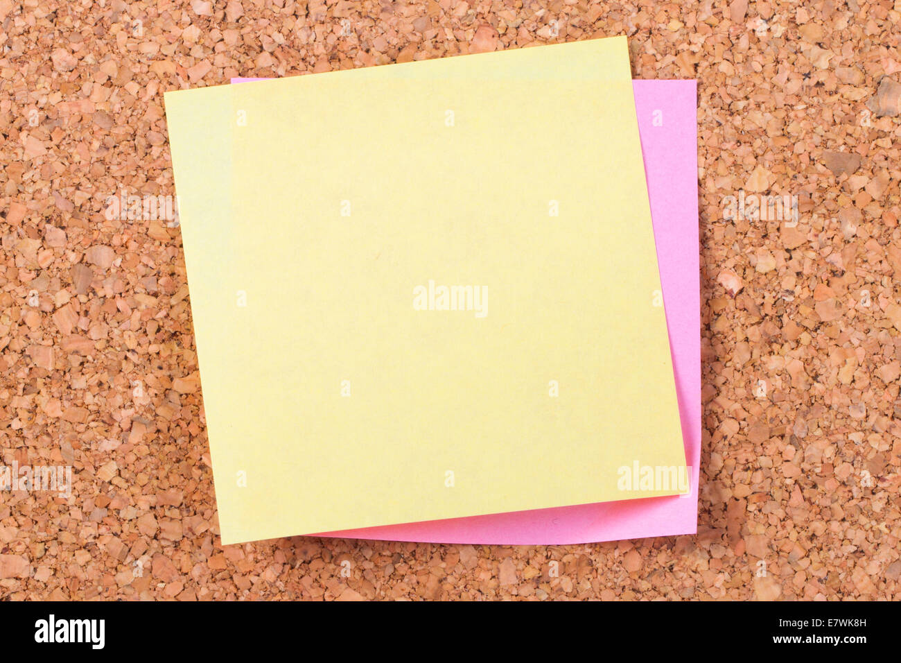 Blank, empty, yellow sticky post it note for your message on cork ...