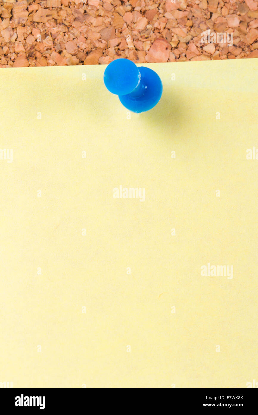 Blank, empty, yellow sticky post it note for your message on cork ...