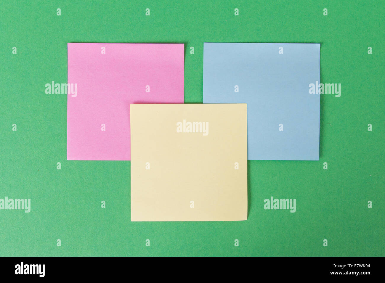 Blank, pink, yellow and blue sticky post it notes for your messages on ...