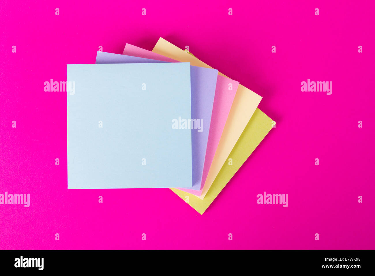 Stack of sticky post it blocks on pink background Stock Photo - Alamy