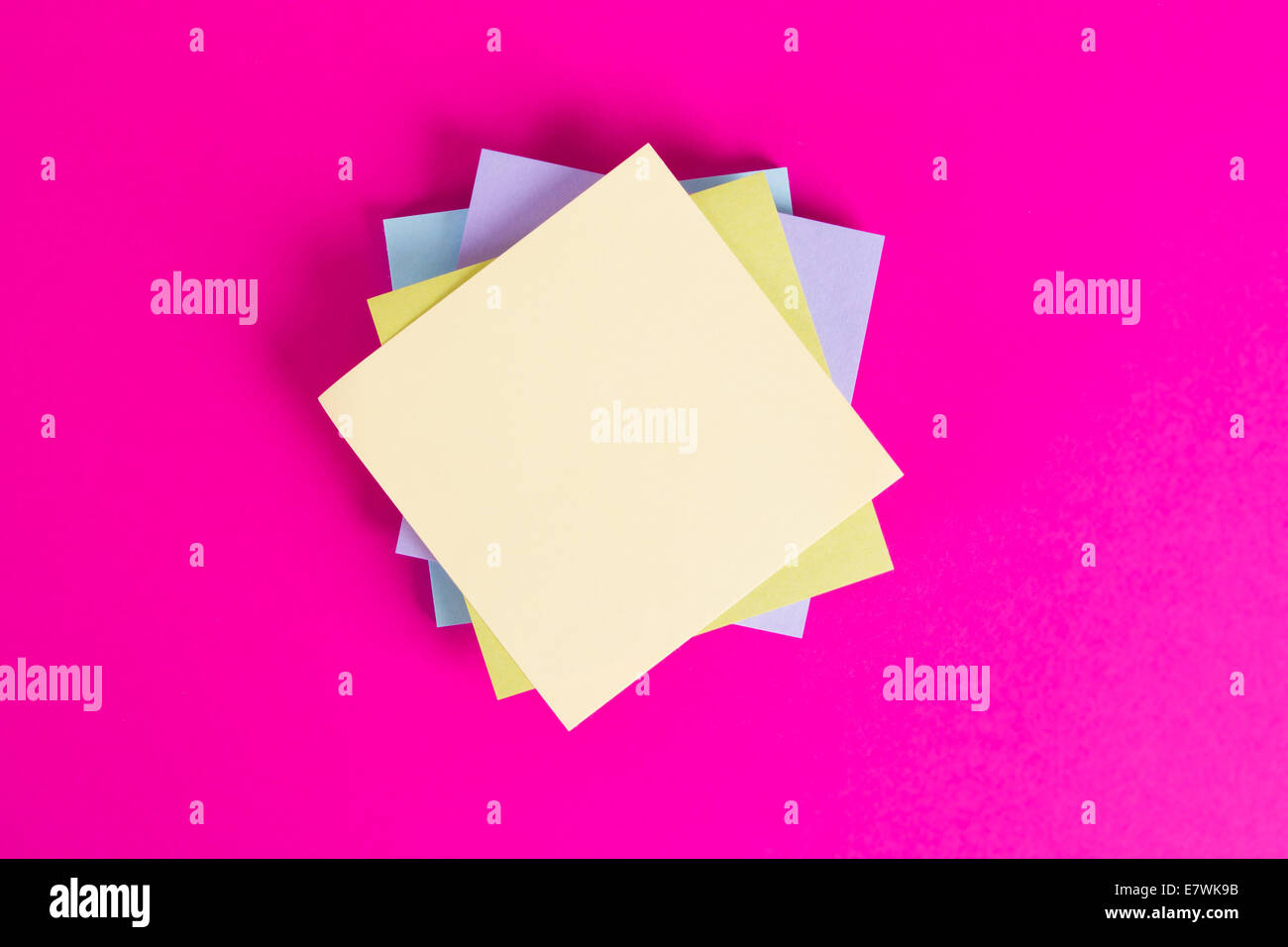 Stack of sticky post it blocks on pink background Stock Photo - Alamy