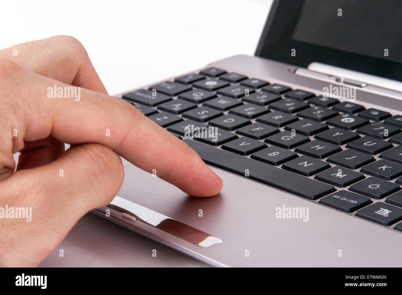 Index finger of hand touching touchpad on laptop, isolated on white ...
