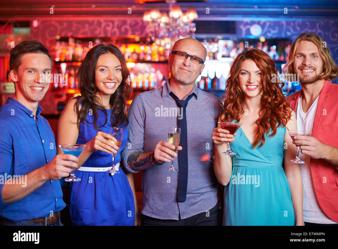Group of boozing people with drinks looking at camera at party Stock ...