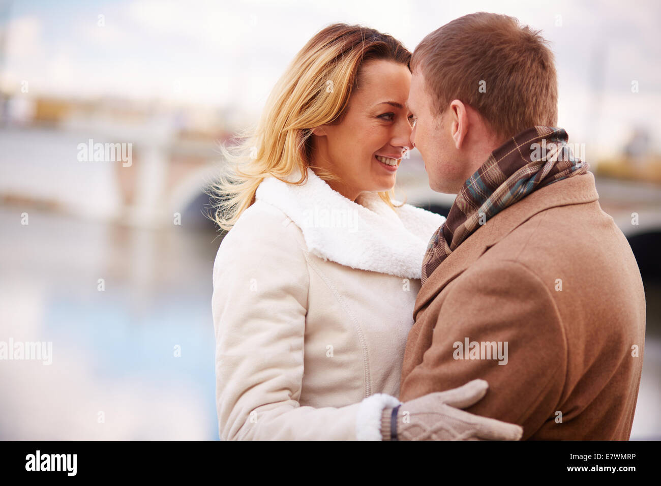 Portrait of amorous man and woman standing face to face outside Stock ...