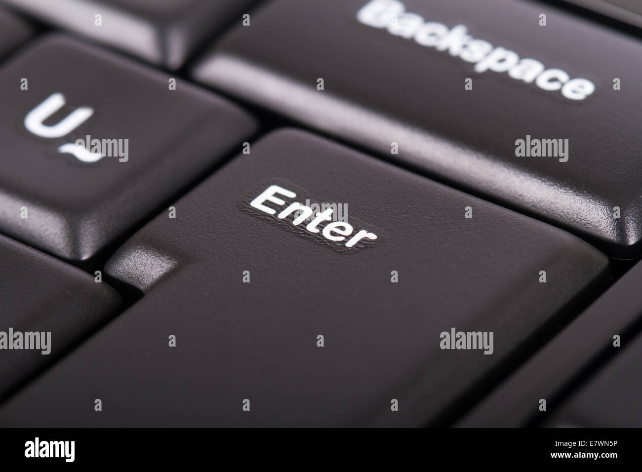 Enter key on black computer keyboard Stock Photo - Alamy