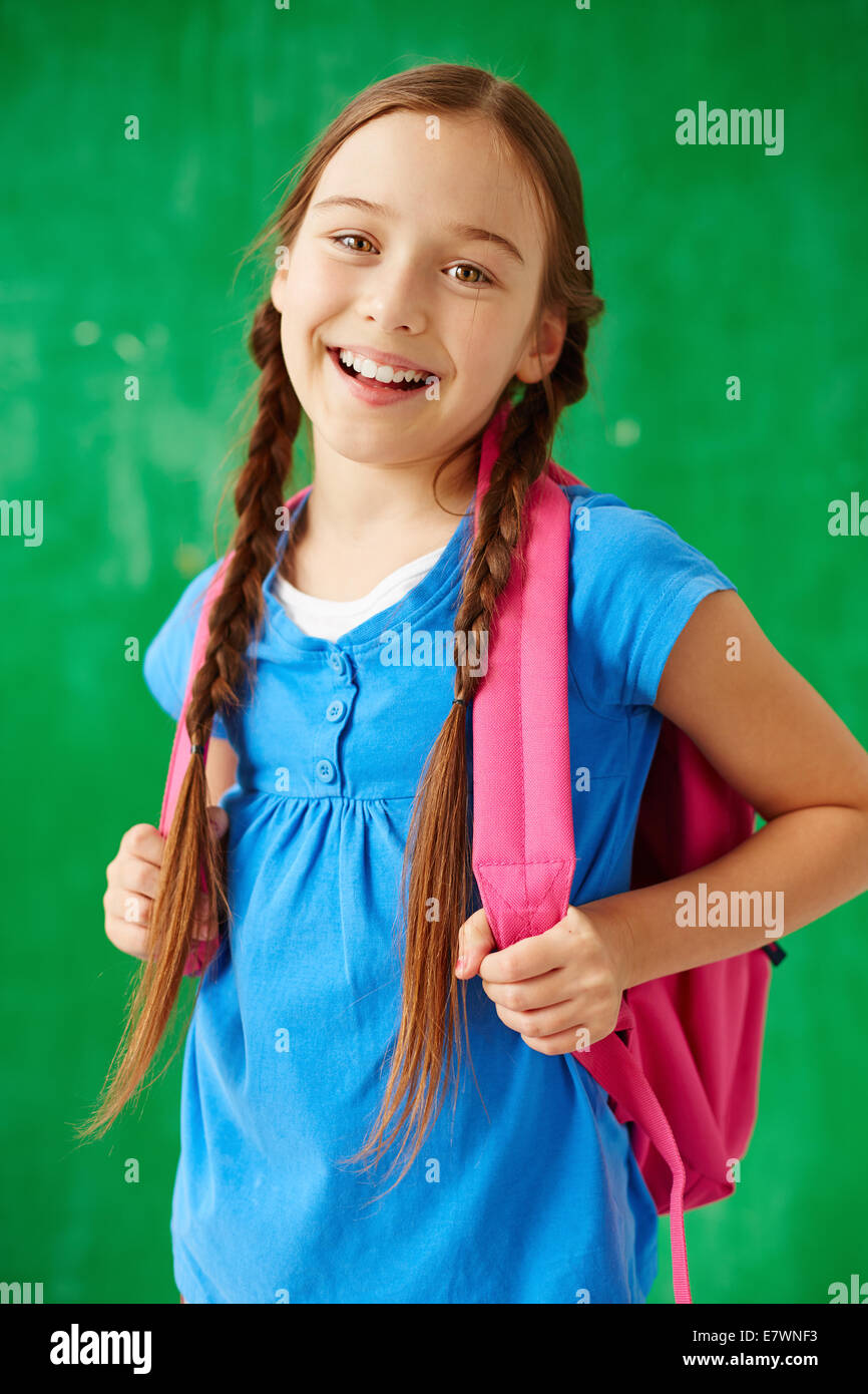 Cheerful child with backpack looking at camera in isolation Stock Photo ...