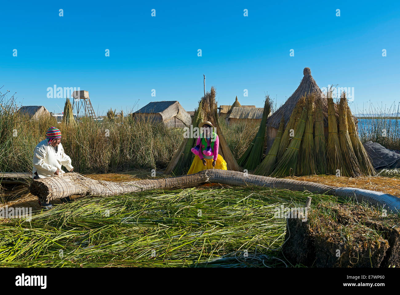 Uros working on the floating islands of the Uros on Lake Titicaca, Puno ...