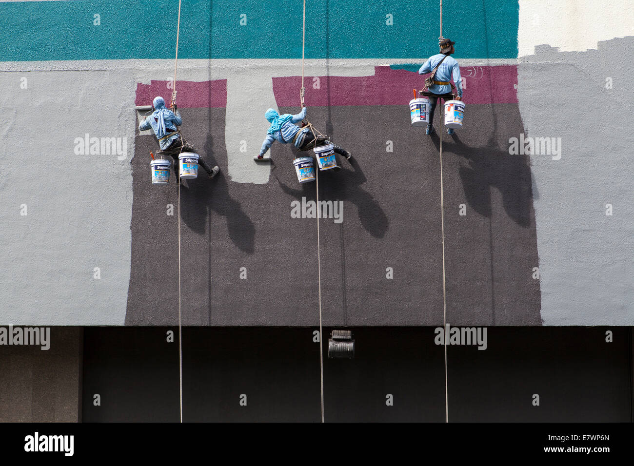 Decorators painting the façade of a high-rise building, Sukhumvit Road ...