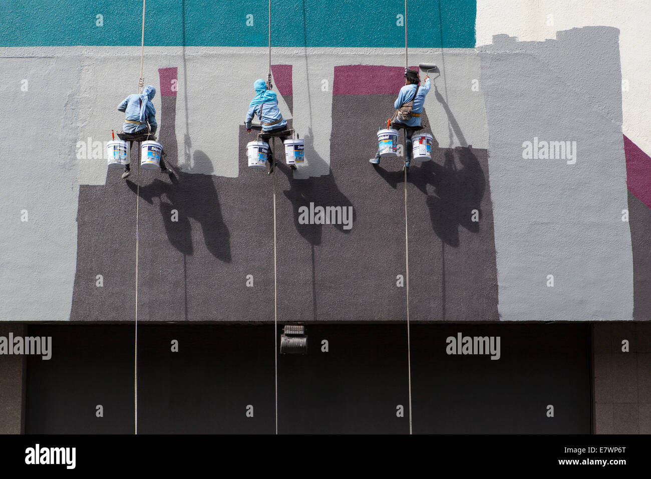 Decorators painting the façade of a high-rise building, Sukhumvit Road ...