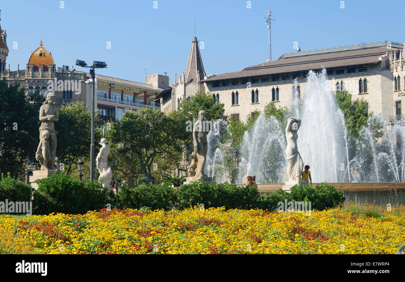 Placa Catalunya fountains and flowerbed with Spanish colors red and ...