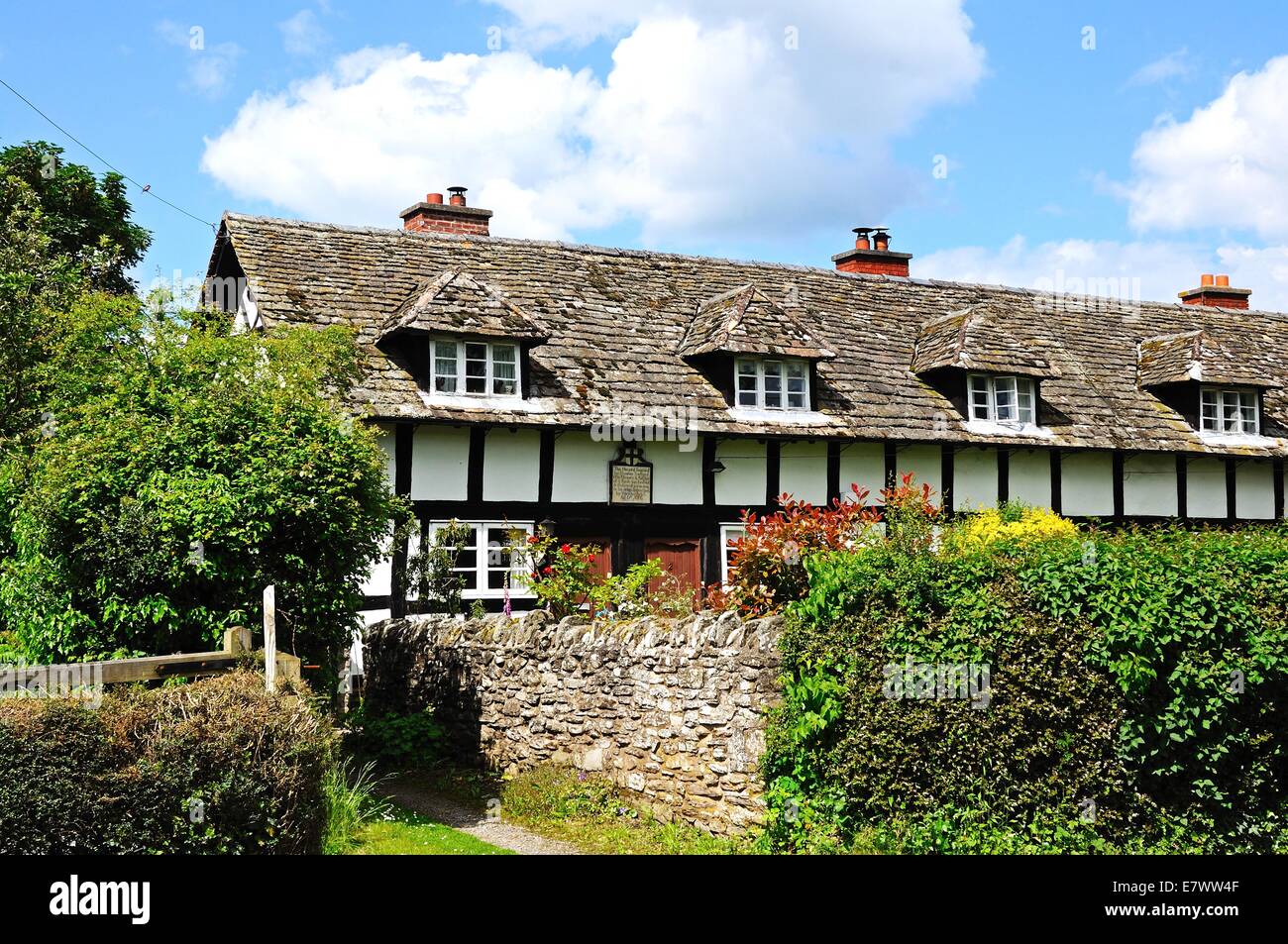 Traditional white timbered former cottage hospital with sign along East ...