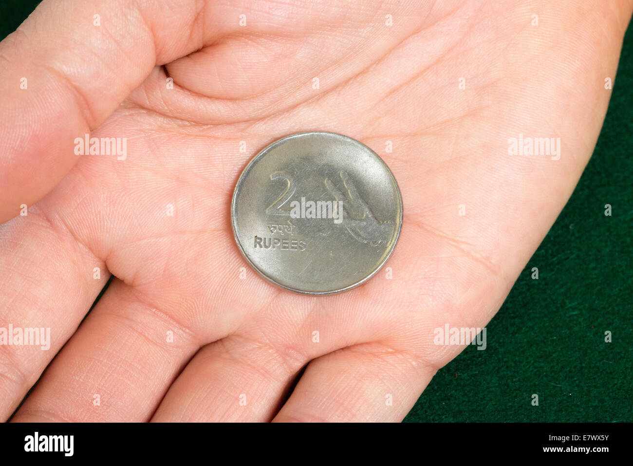 Indian coin Two Rupees in a woman's hand Stock Photo - Alamy