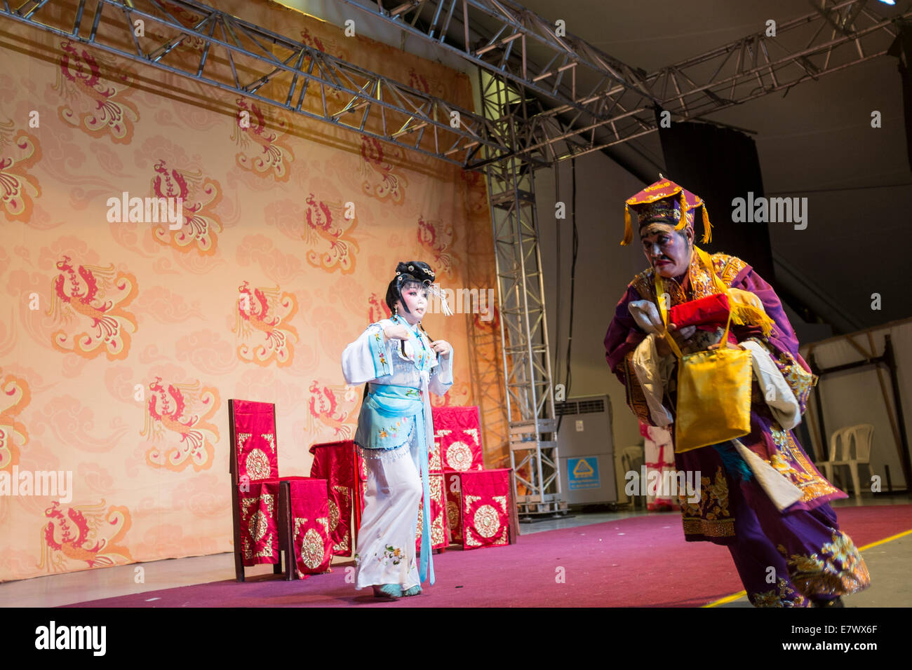 Chinese Opera performers perform on stage in Hong Lim Park in Singapore ...
