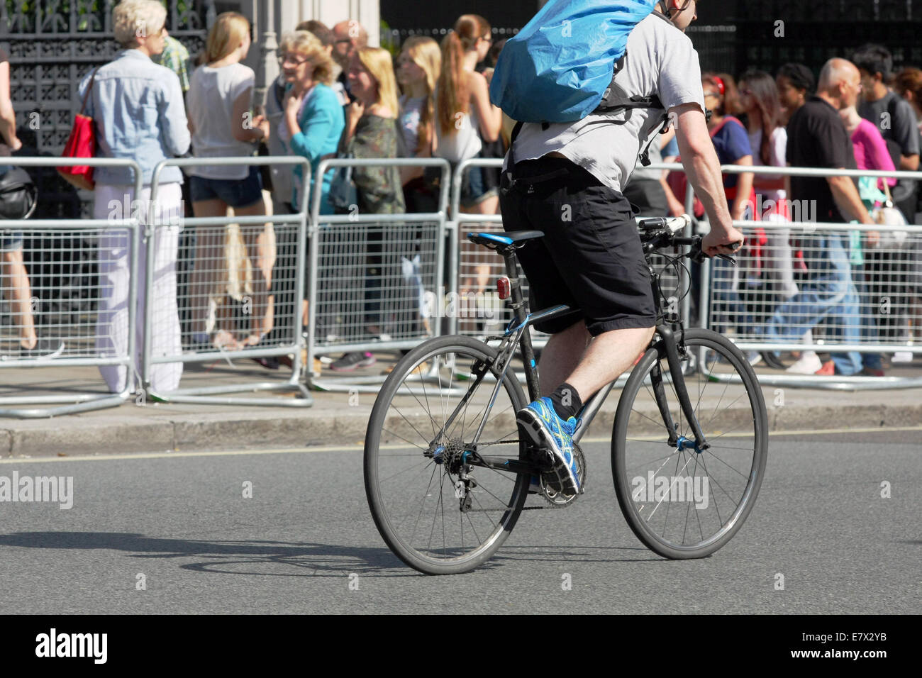 A cyclist riding in Parliament Square, London. Pedestrians walking on ...
