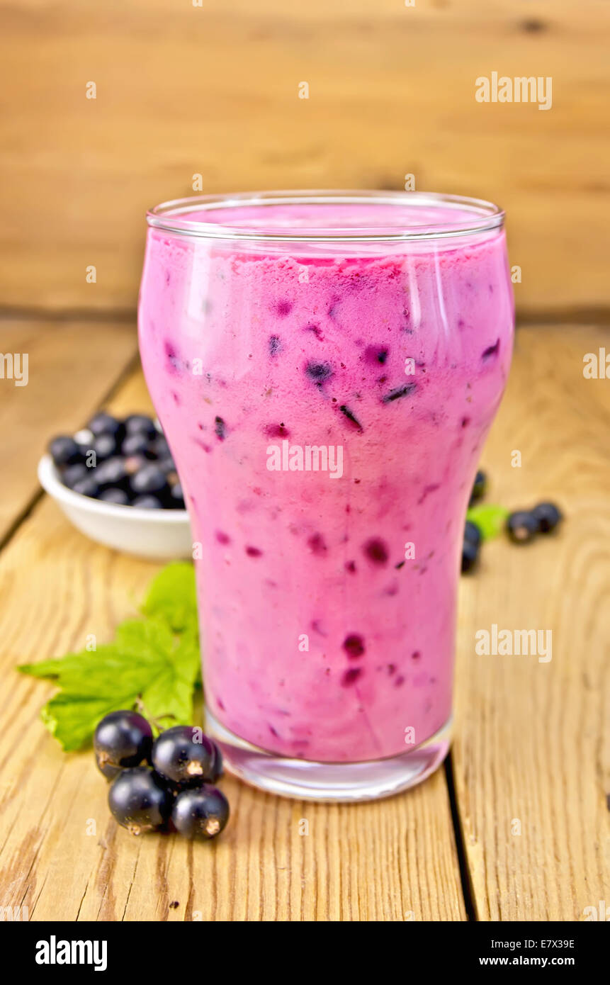 Milkshake with black currants in a glass, currants against the ...