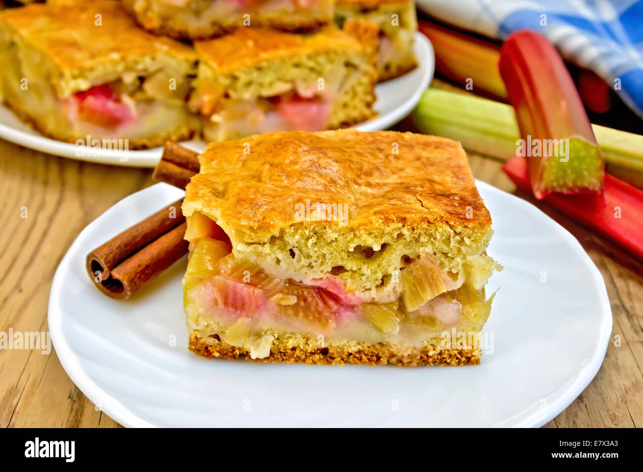A piece of sweet cake with rhubarb, rhubarb stalks, cinnamon, blue ...