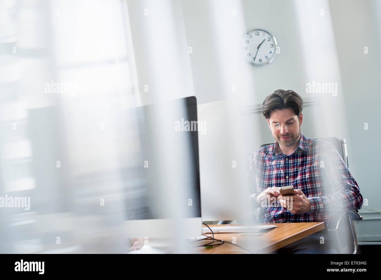 View through an office partition of a man seated at a desk Stock Photo ...