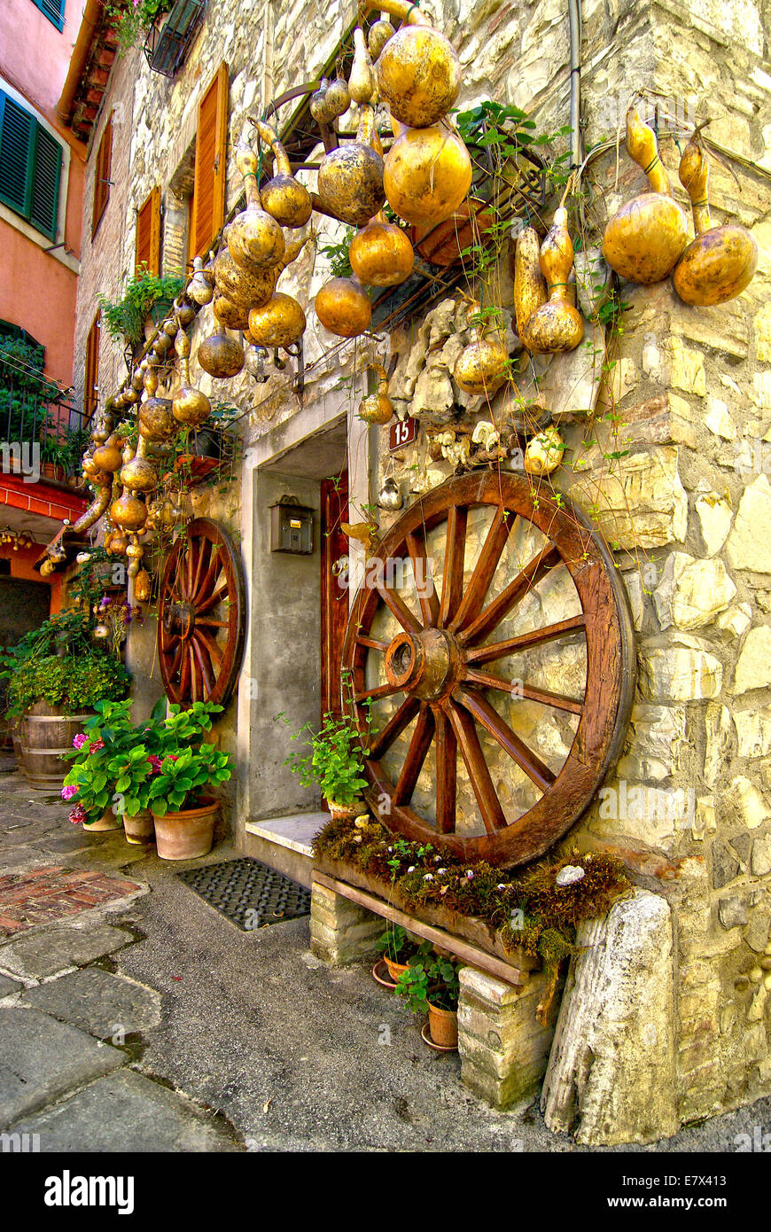 Pumpkins and gold wagon wheels decorating a Tuscan house Stock Photo ...