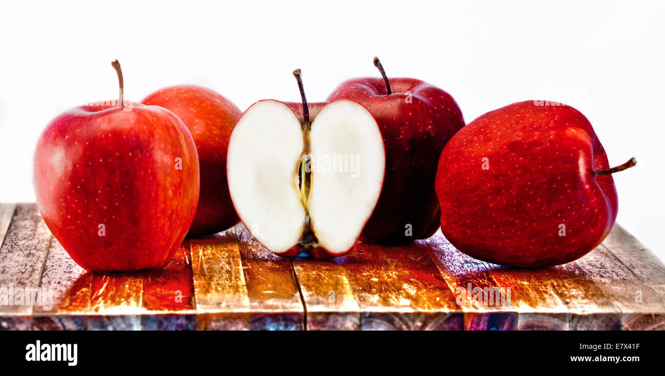 Four red apples and half an apple on wooden cutting board Stock Photo ...