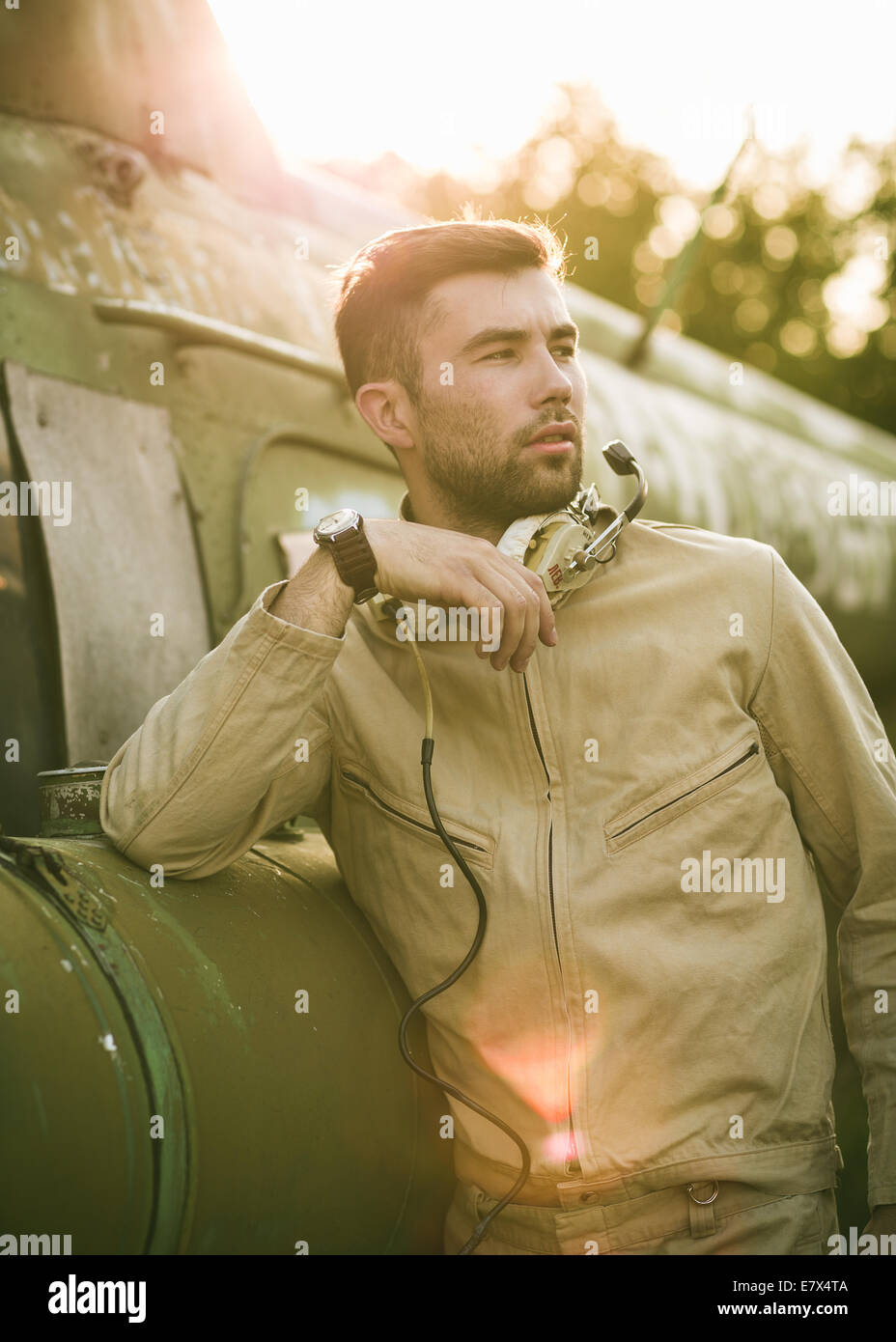 Young serious pilot posing near the helicopter Stock Photo - Alamy