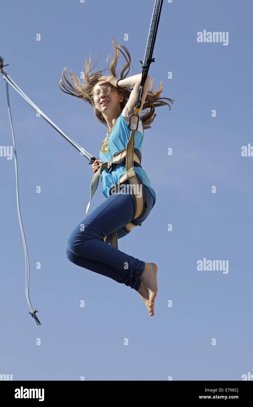 girl on a bungee trampoline Stock Photo - Alamy