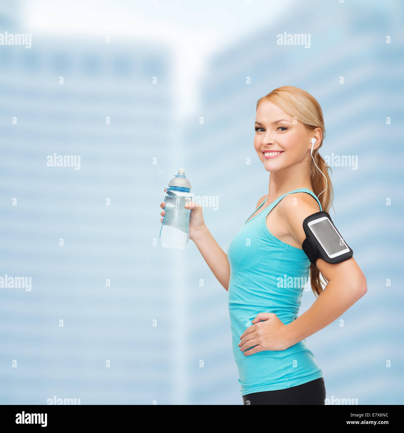 sporty woman running with smartphone and earphones Stock Photo - Alamy